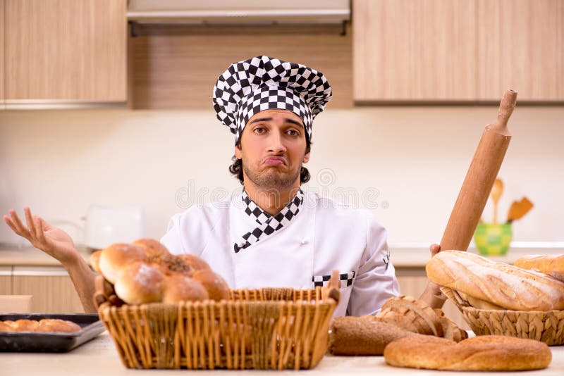 The Young Male Baker Working in Kitchen Stock Photo - Image of male ...
