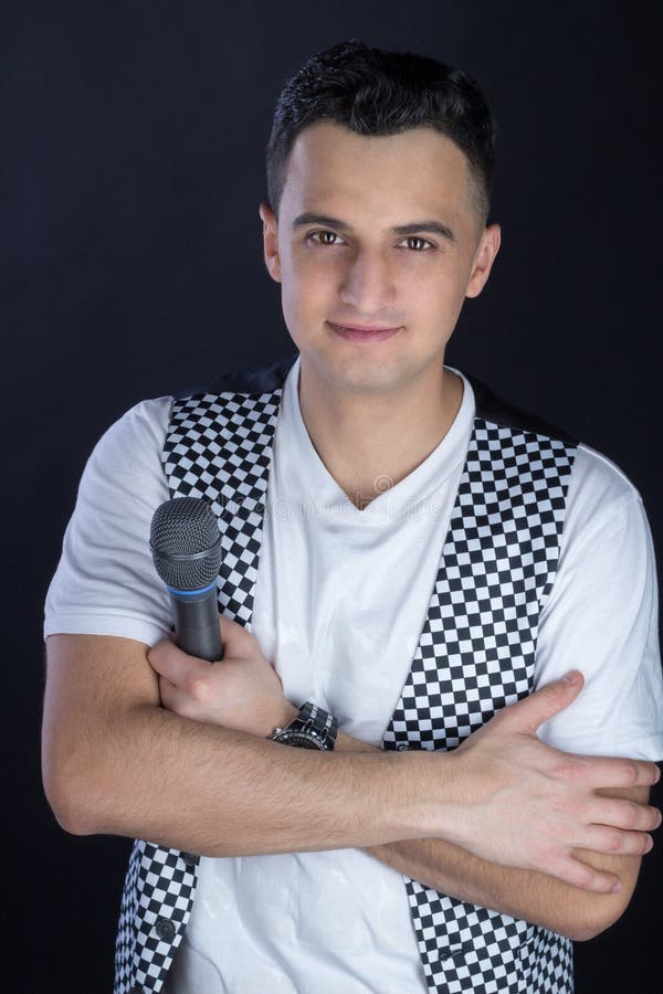 Young Male Black-haired Pop Singer Performs Singing To Microphone Stock ...