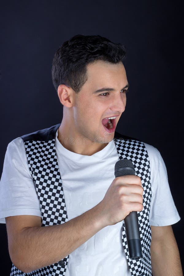 Young Male Black-haired Pop Singer Poses with Microphone Stock Photo ...