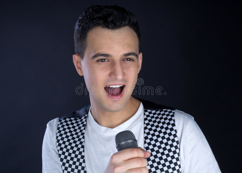 Young Male Black-haired Pop Singer Sings To Microphone Stock Image ...