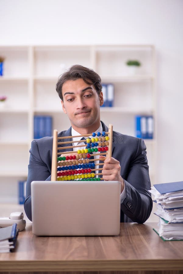 Young Male Bookkeeper in Budget Planning Concept Holding Abacus Stock ...