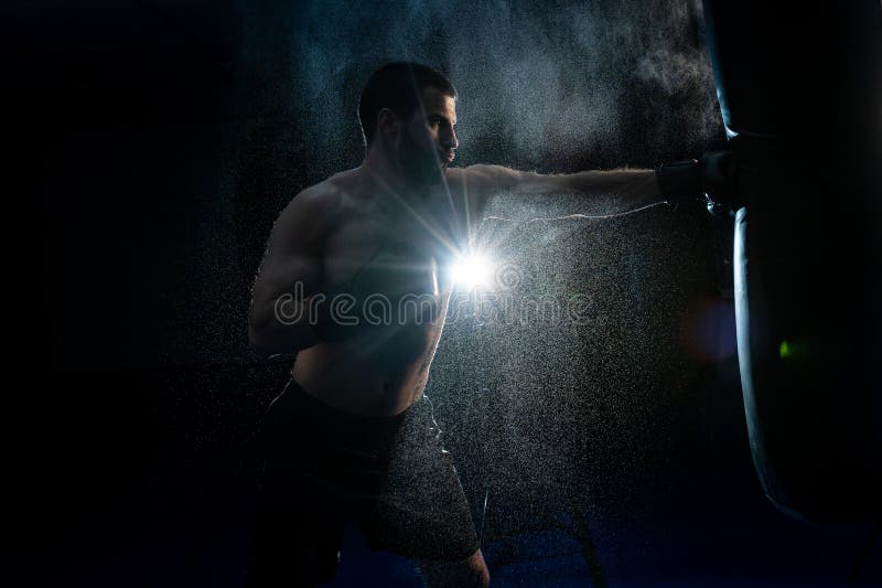 Male Boxer Hitting a Huge Punching Bag at a Boxing Studio. Man Boxer ...