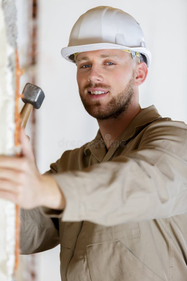 Young Male Builder Holding Sledge Hammer Stock Photo - Image of ...