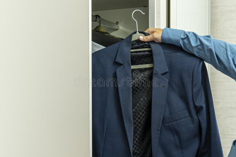 A Young Male Businessman Chooses a Jacket. Dress Code at Work ...