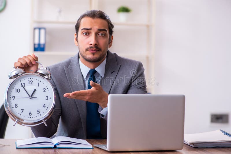 Young Male Businessman Reading Books at Workplace Stock Image - Image ...