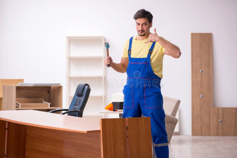 Young Male Carpenter Repairing Desk in the Office Stock Image - Image ...