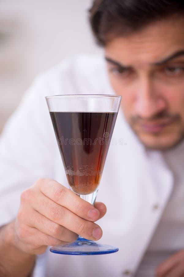 Young Male Chemist Examining Soft Drink at the Lab Stock Image - Image ...