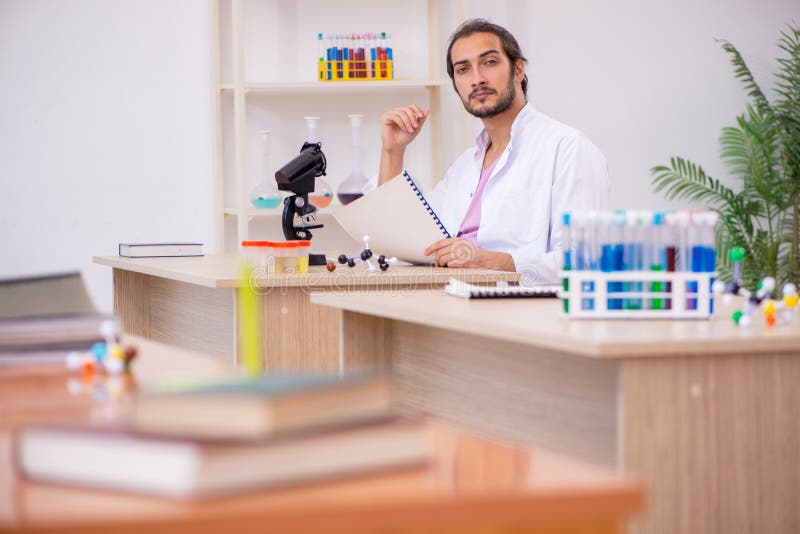 Young Male Chemist Sitting at the Desk in the Classroom Stock Photo ...