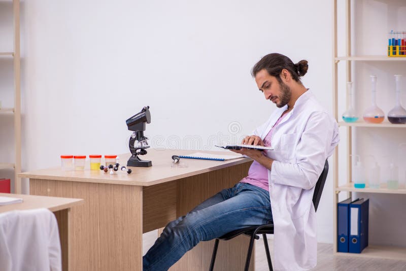 Young Male Chemist Sitting at the Desk in the Classroom Stock Photo ...