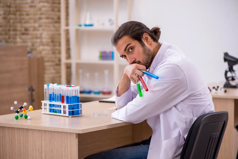 Young Male Chemist Sitting at the Desk in the Classroom Stock Image ...