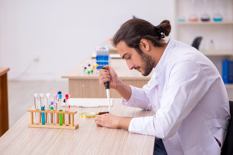 Young Male Chemist Sitting at the Desk in the Classroom Stock Image ...