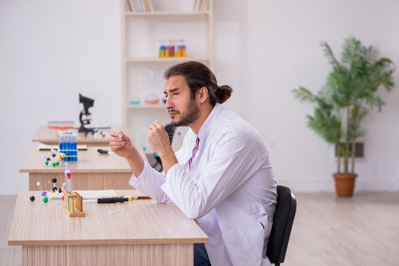 Young Male Chemist Sitting at the Desk in the Classroom Stock Image ...