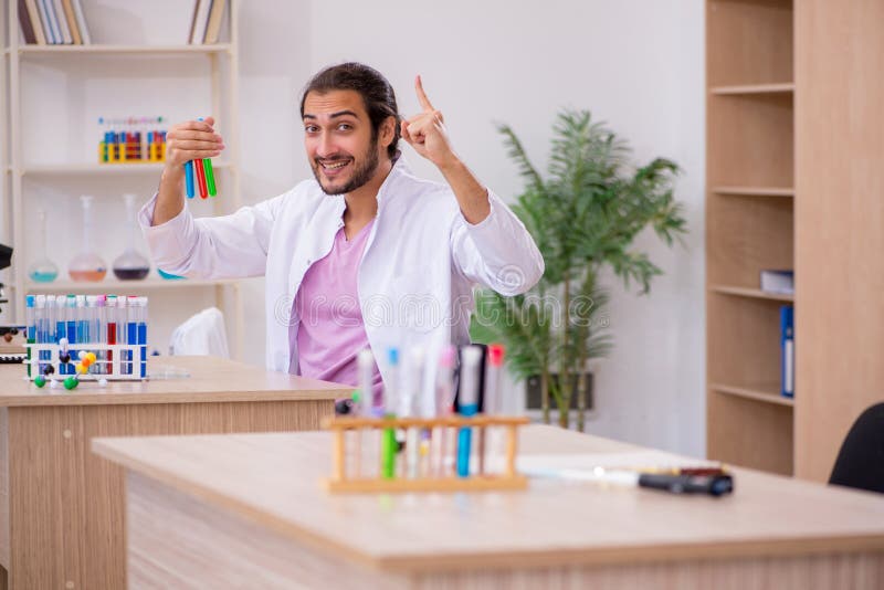 Young Male Chemist Sitting at the Desk in the Classroom Stock Photo ...