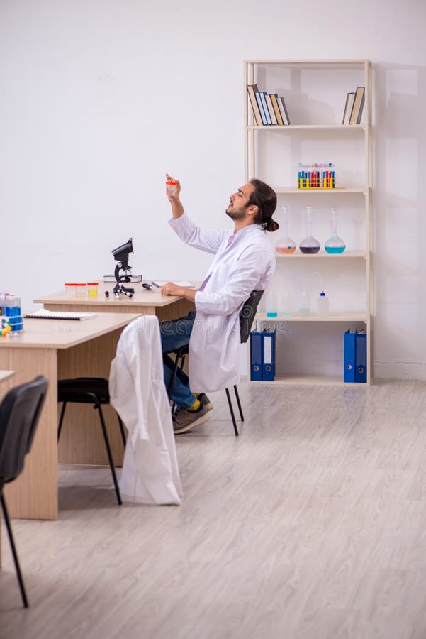 Young Male Chemist Sitting at the Desk in the Classroom Stock Photo ...