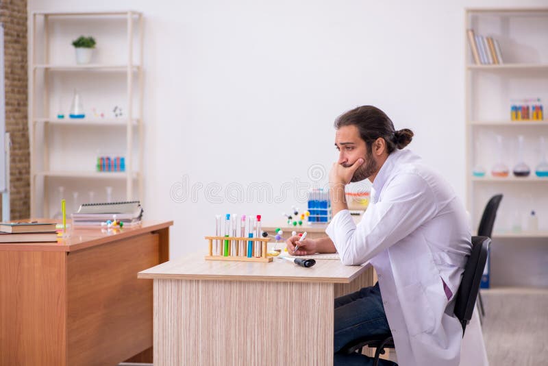 Young Male Chemist Sitting at the Desk in the Classroom Stock Photo ...
