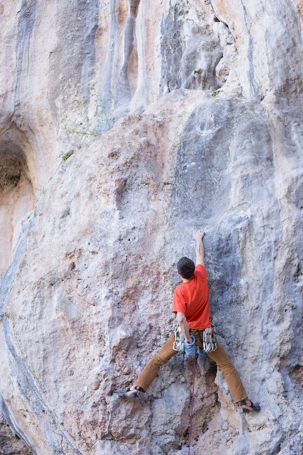 Young Male Climber Hanging by a Cliff. Stock Photo - Image of effort ...