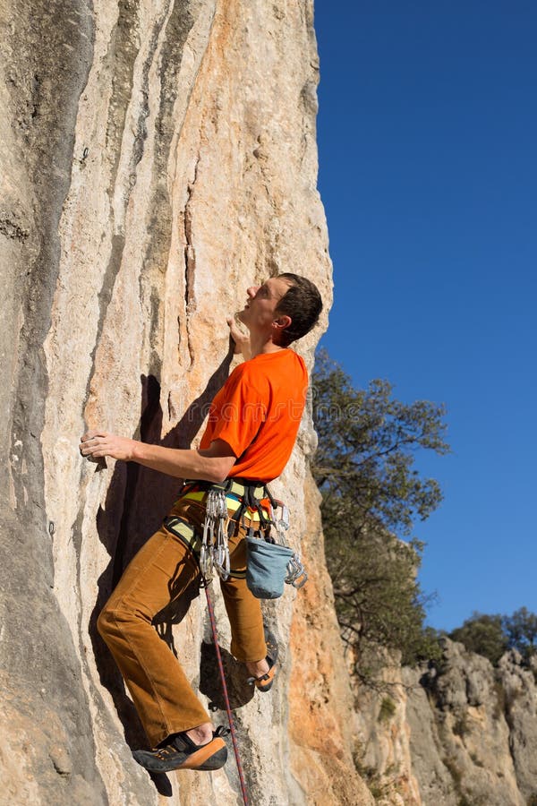 Young Male Climber Hanging by a Cliff. Stock Image - Image of mountain ...