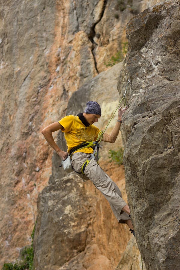 Young Male Climber Hanging by a Cliff. Stock Image - Image of height ...