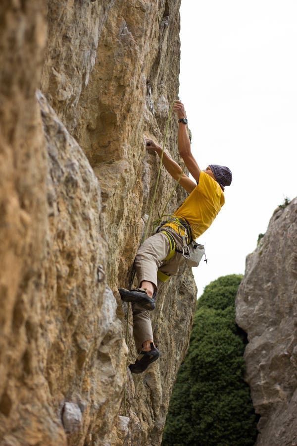 Young Male Climber Hanging by a Cliff. Stock Image - Image of cave ...