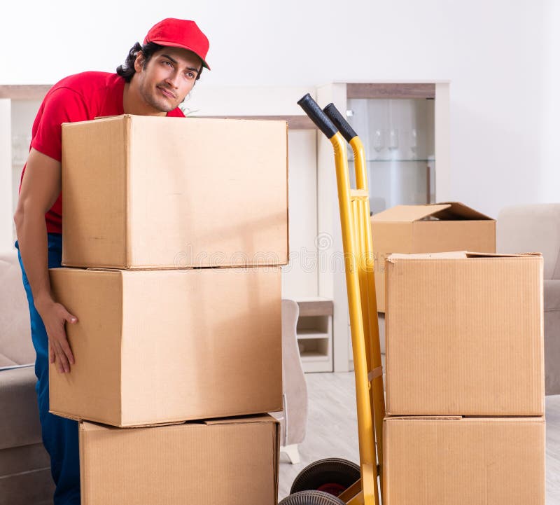 Young Male Contractor with Boxes Working Indoors Stock Image - Image of ...