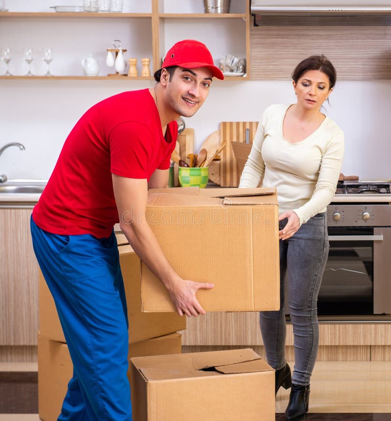 Young Male Contractor and Female Customer in Moving Concept Stock Image - Image of cardboard ...
