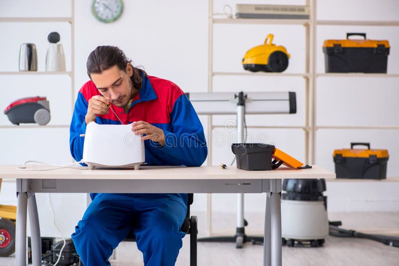 Young Male Contractor Repairing Toaster at Workshop Stock Image - Image ...