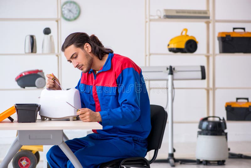 Young Male Contractor Repairing Toaster at Workshop Stock Photo - Image ...