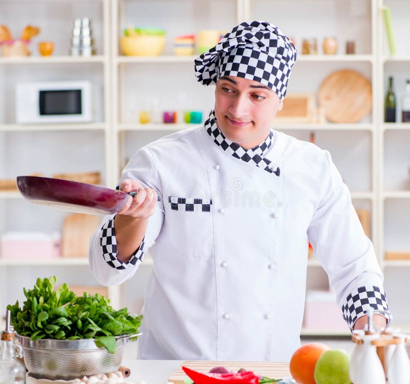 Young Male Cook Working in the Kitchen Stock Photo - Image of green ...