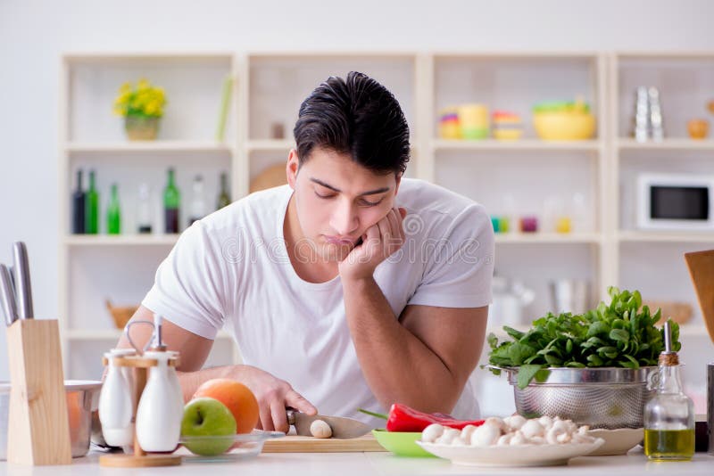 The young male cook working in the kitchen. Fresh, gourmet. - Stock ...