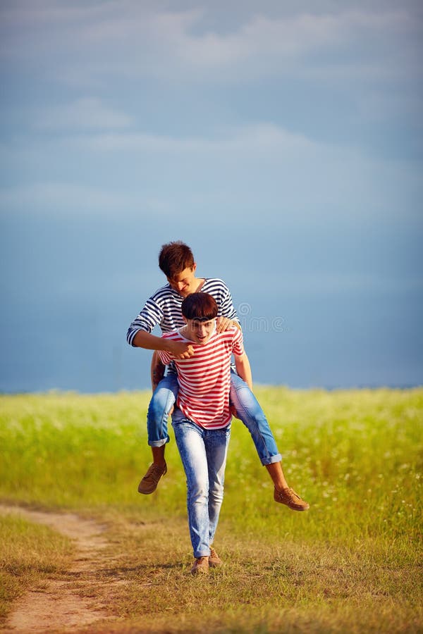 Young Male Couple Having Fun at Spring Field Stock Image - Image of ...