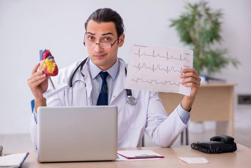 Young Male Doctor Cardiologist Looking Electrocardiogram Stock Photo ...