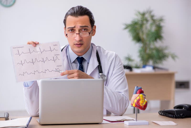 Young Male Doctor Cardiologist Looking Electrocardiogram Stock Image ...