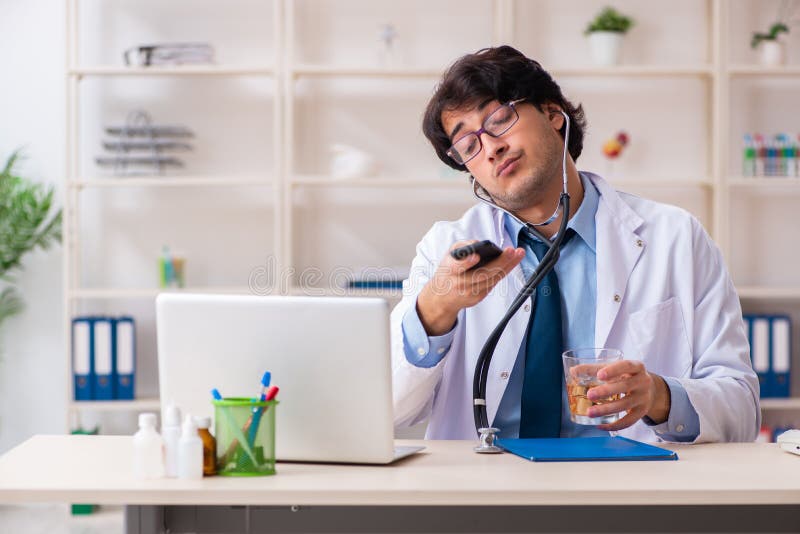 The Young Male Doctor Drinking in the Office Stock Image - Image of ...