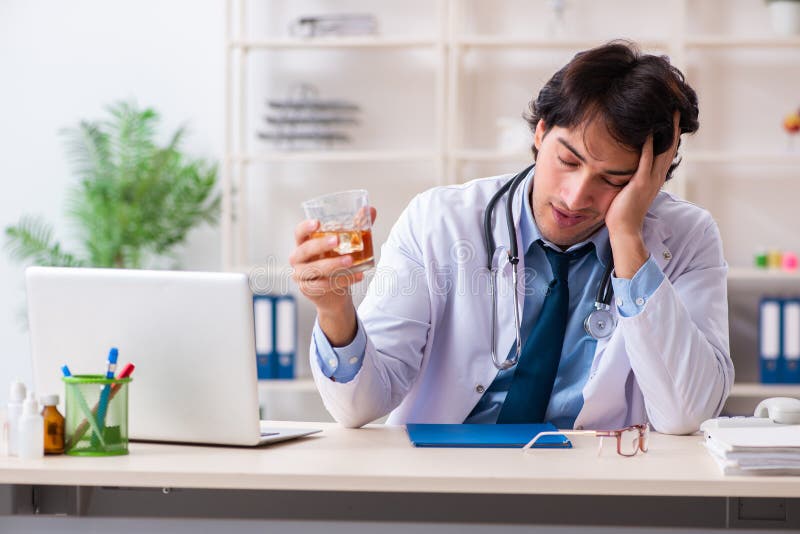 The Young Male Doctor Drinking in the Office Stock Photo - Image of ...