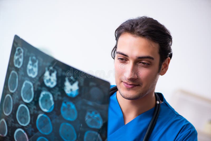 Young Male Doctor Looking at X-ray Images Stock Image - Image of ...