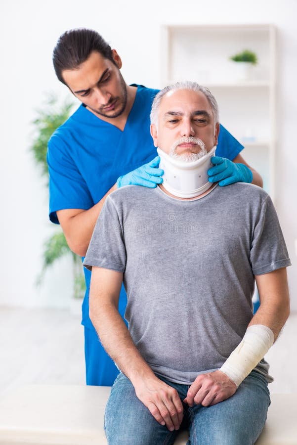 Young Male Doctor and Old Patient in First Aid Concept Stock Photo ...