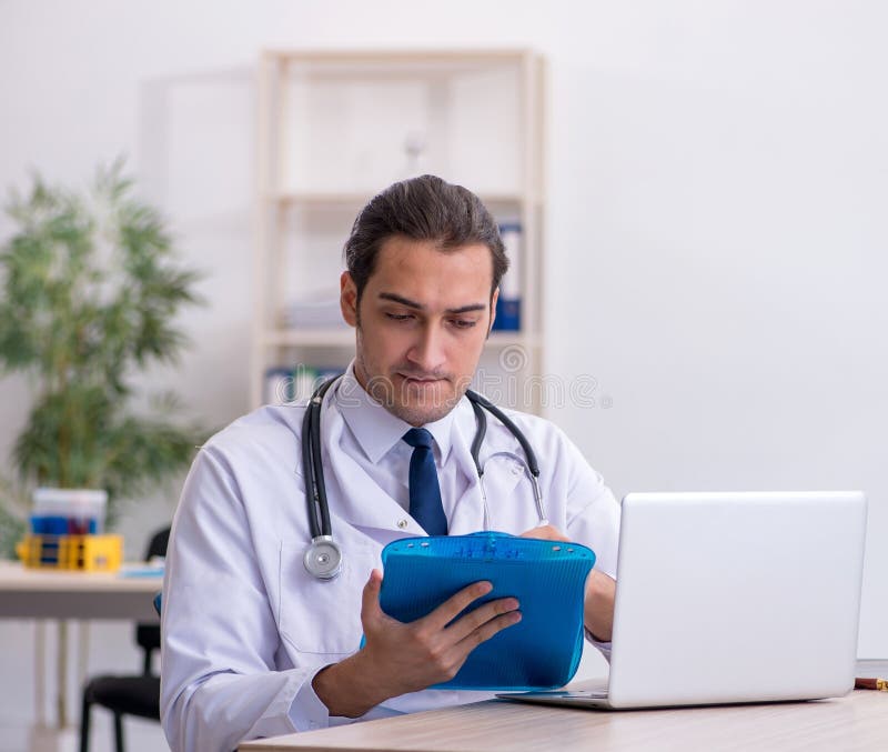 Young Male Doctor Taking Notes at the Hospital Stock Image - Image of ...