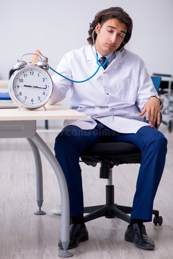 Young Male Doctor in Time Management Concept Stock Image - Image of ...