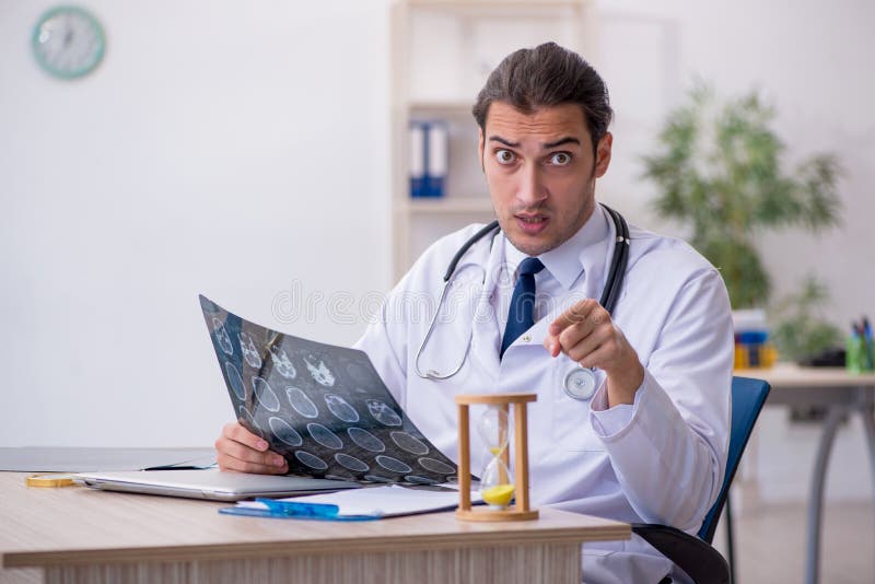 Young Male Doctor in Time Management Concept Stock Image - Image of ...