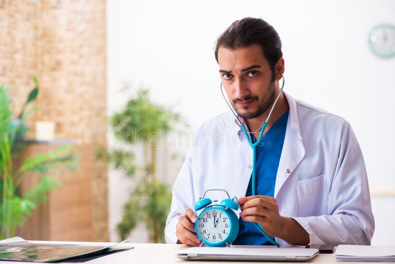 Young Male Doctor in Time Management Concept Stock Image - Image of ...