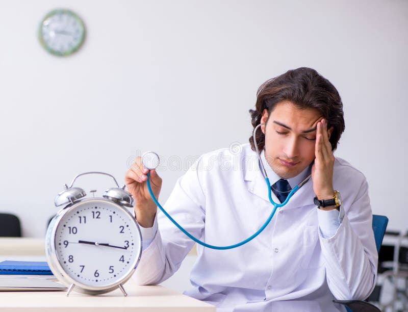 Young Male Doctor in Time Management Concept Stock Photo - Image of ...