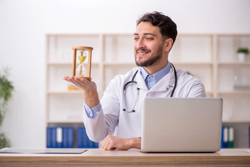 Young Male Doctor in Time Management Concept Stock Image - Image of ...