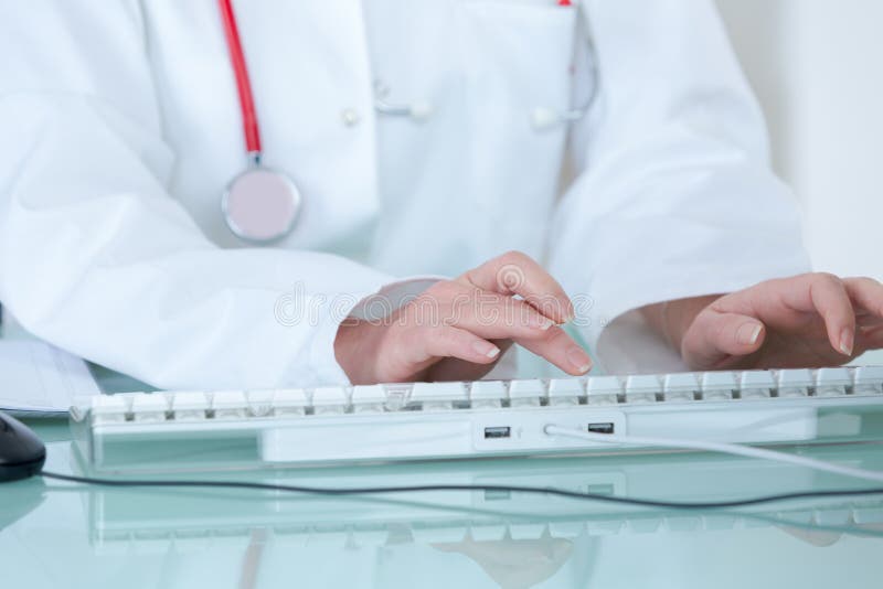 Young Male Doctor Using Keyboard in Office Stock Photo - Image of ...
