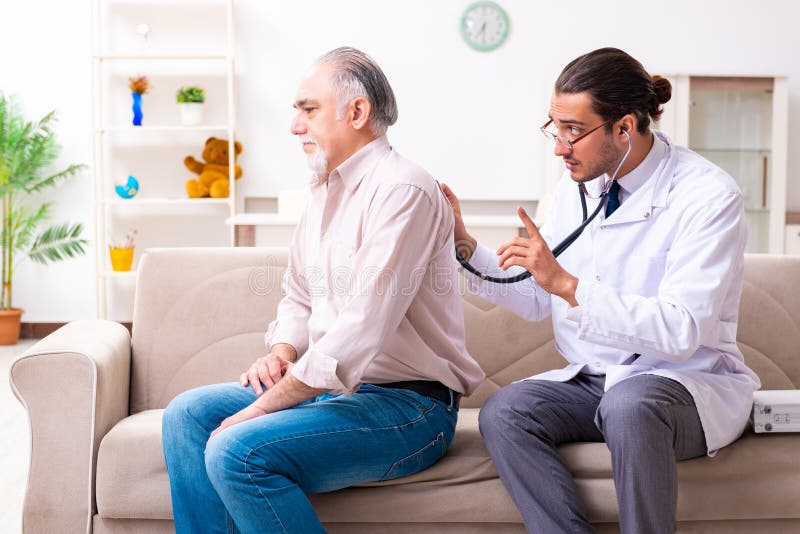 Young Male Doctor Visiting Old Patient at Home Stock Photo - Image of ...