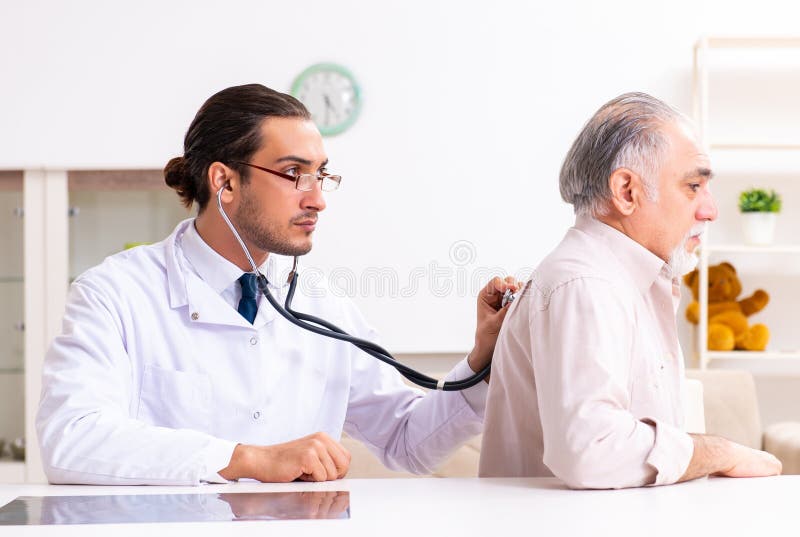 Young Male Doctor Visiting Old Patient at Home Stock Image - Image of ...