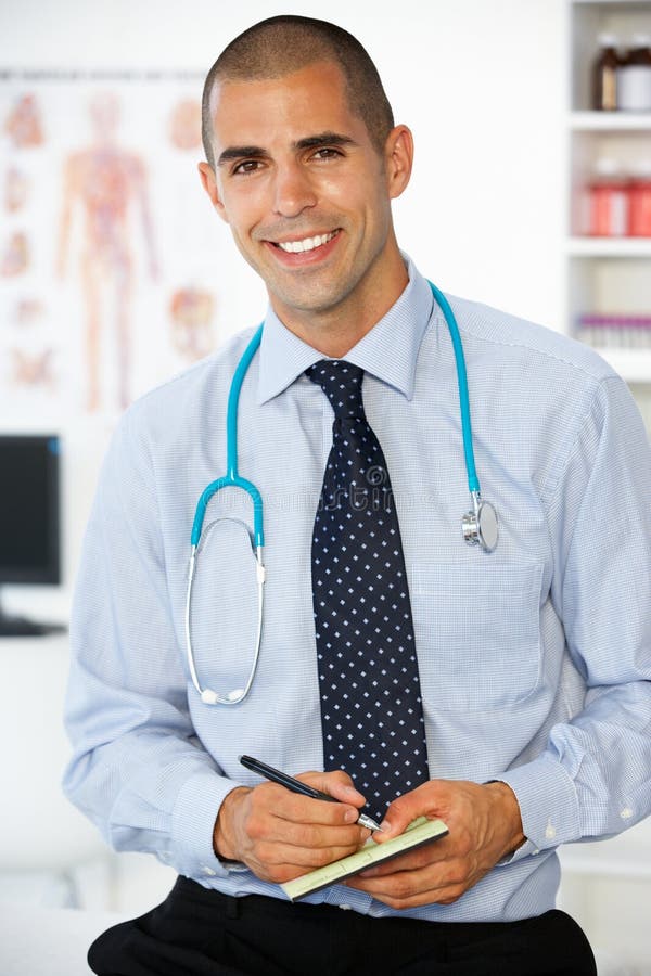 Young Male Doctor Writing Prescription Stock Photo - Image of surgery ...