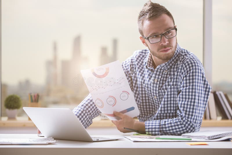 Young male doing paperwork stock photo. Image of laptop - 78219726