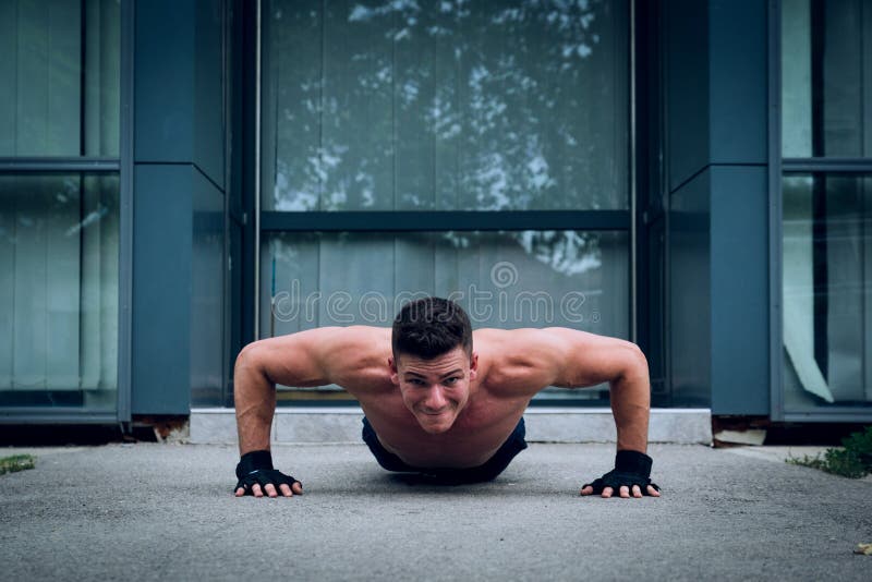 Young Male Doing Push Ups in Front of the Modern Sport Center. S Stock ...