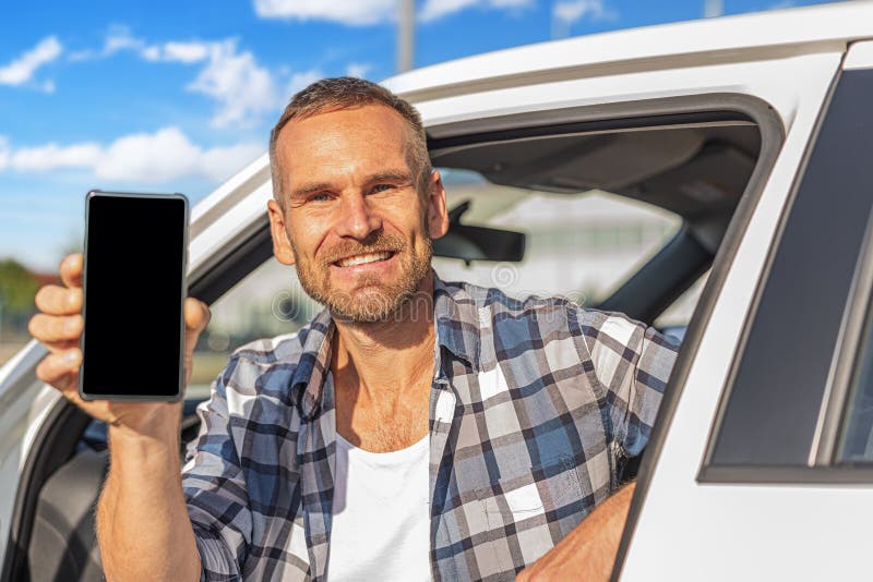 Young Male Driver Showing Smartphone in Car. Stock Image - Image of ...