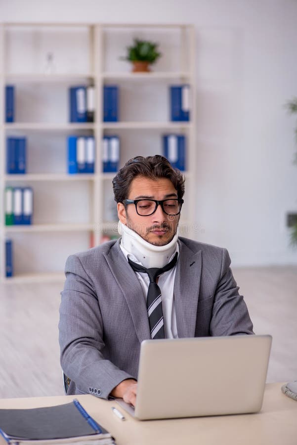 Young Male Employee after Car Accident Working in the Office Stock ...